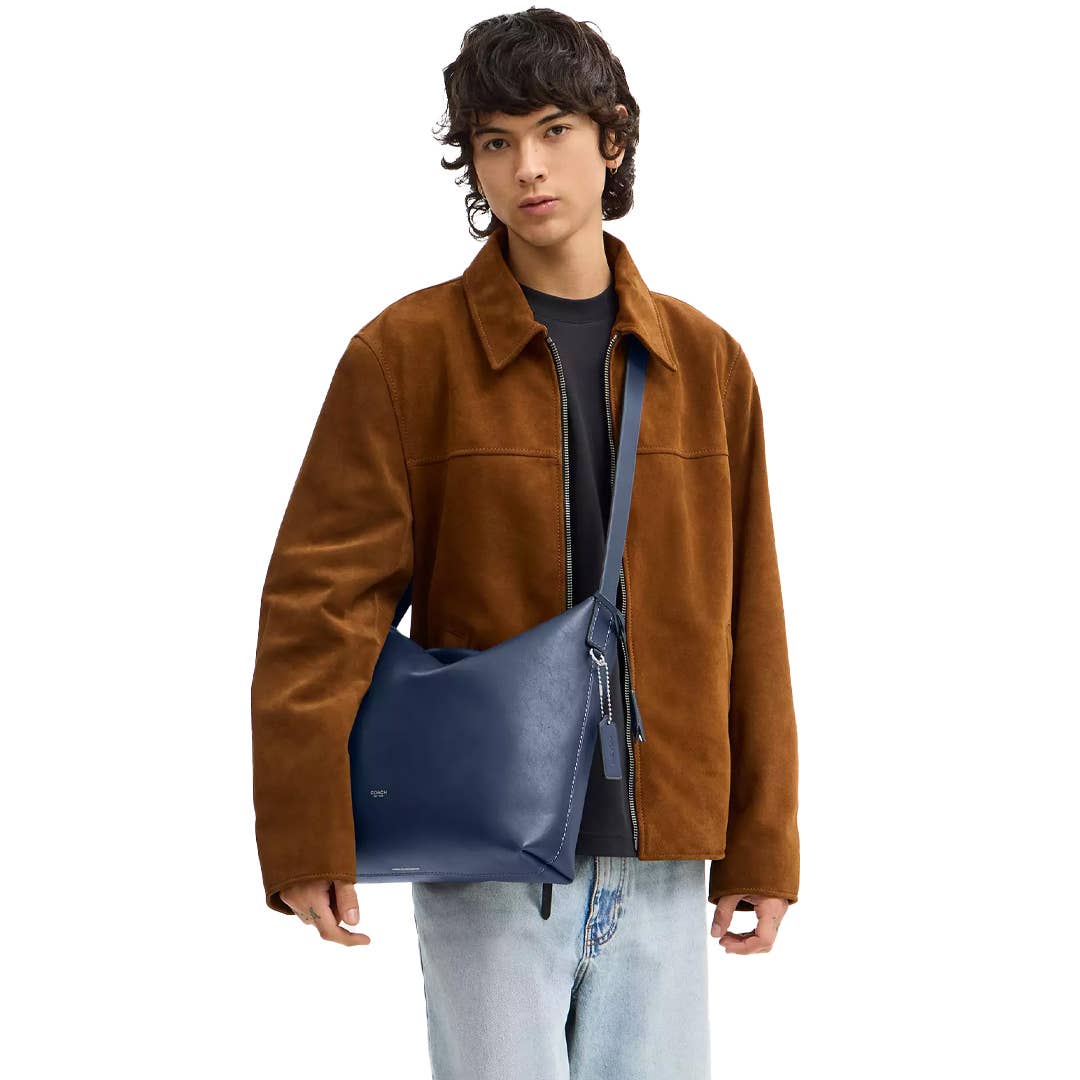 Coach's Mott messenger bag is now available in navy - TheStreet